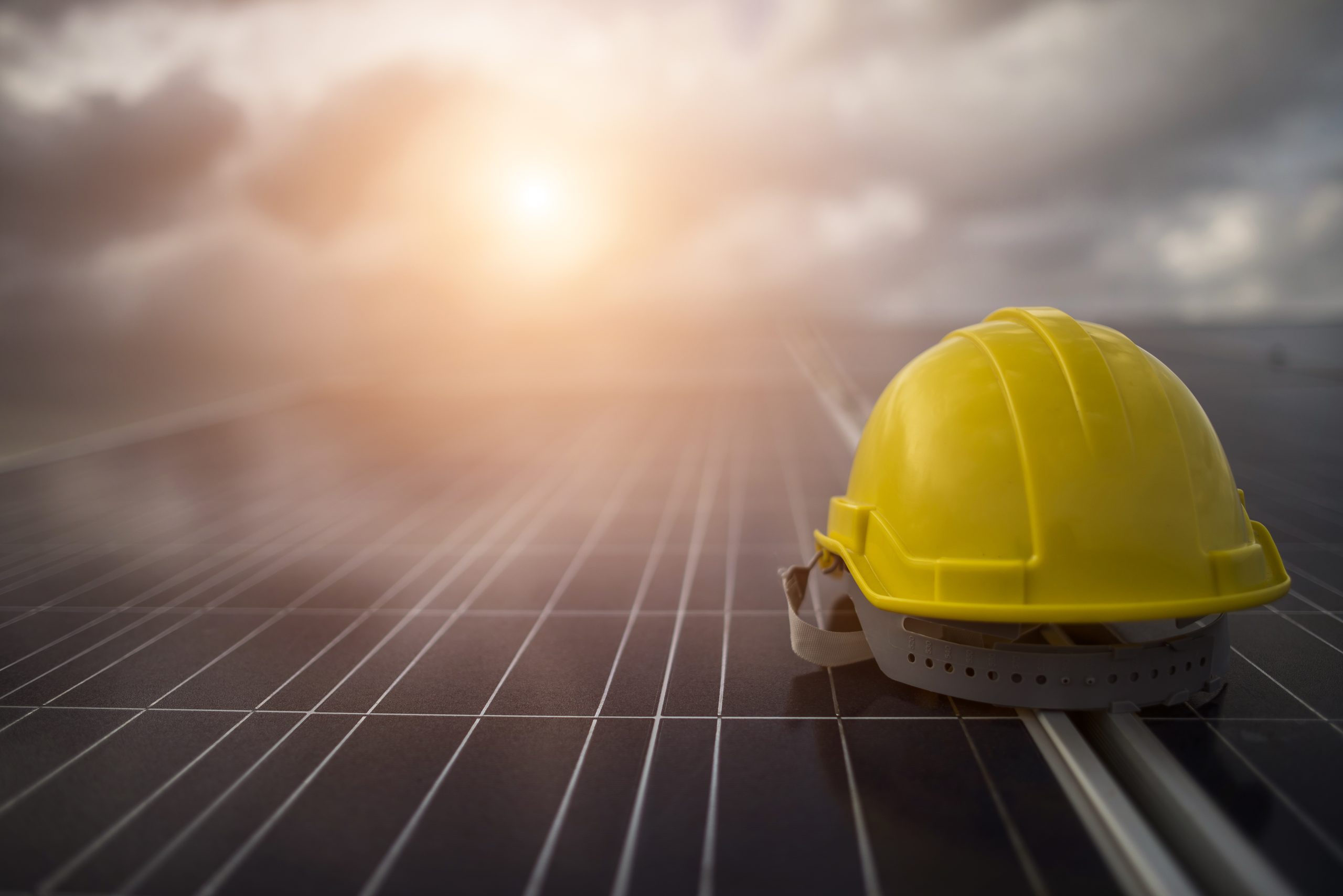 Yellow safety helmet on solar cell panel – Starhub Energy